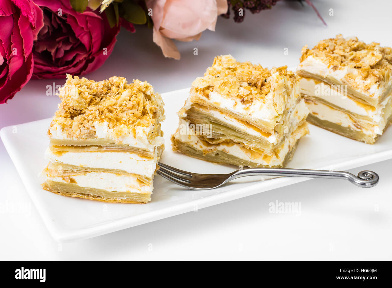 Portion cake of puff pastry with vanilla butter cream Stock Photo - Alamy