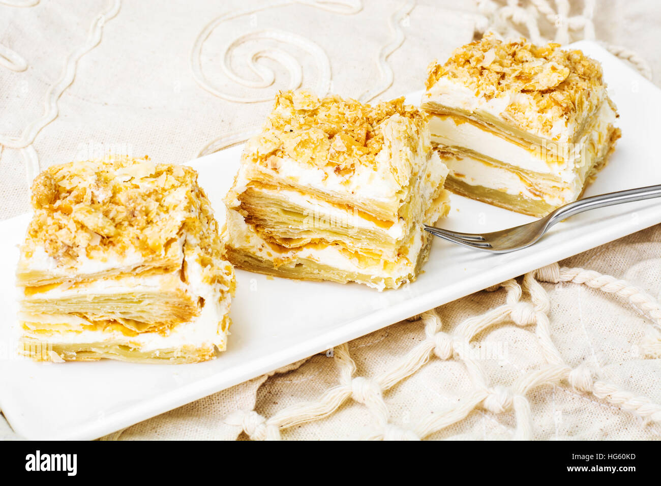 Portion cake of puff pastry with vanilla butter cream Stock Photo - Alamy