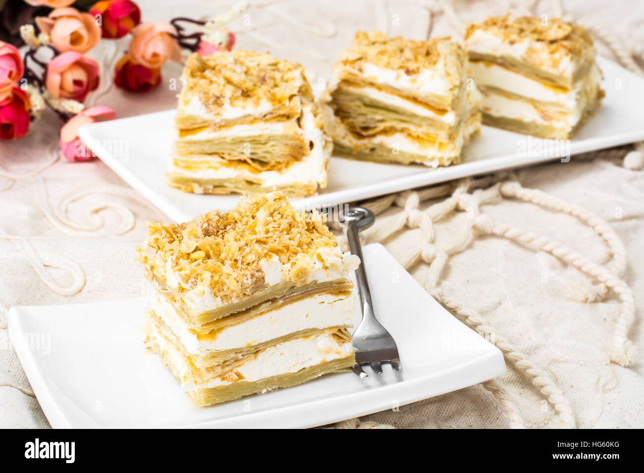 Portion cake of puff pastry with vanilla butter cream Stock Photo - Alamy