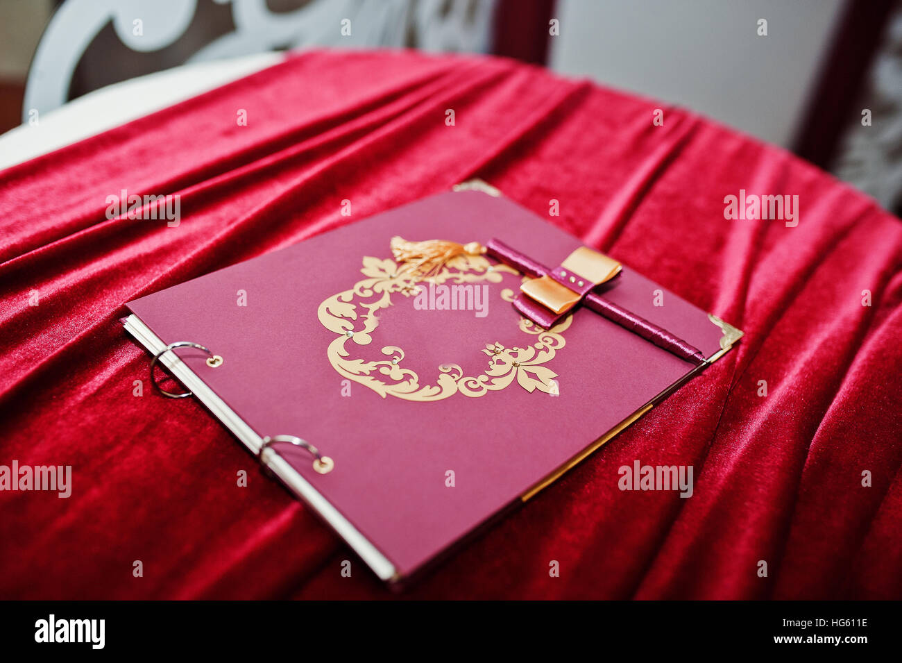 Red guest book on silk table at wedding party Stock Photo - Alamy