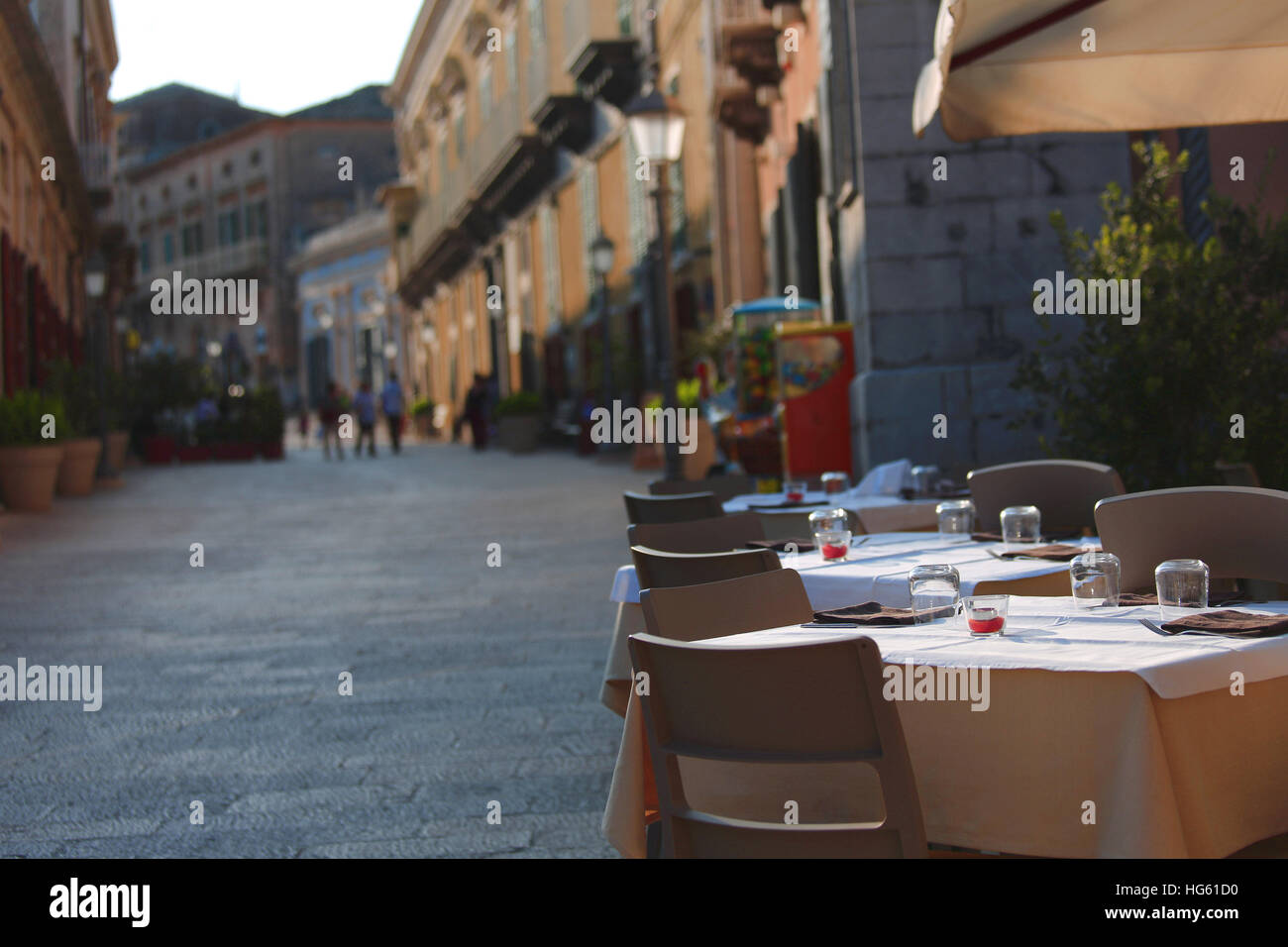 Restaurant tables on a street in Sicily, Italy Stock Photo - Alamy