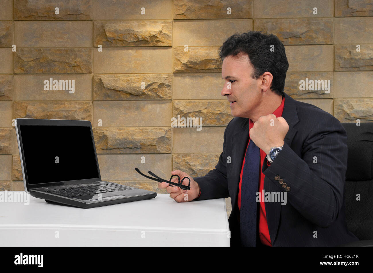 Handsome business man banker or salesman with a computerdoing a fist ...