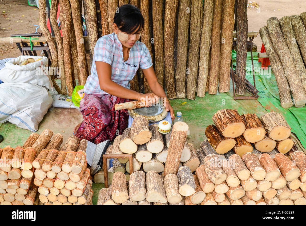 Unidentified burmese woman preparing tanaka, the traditional natural ...