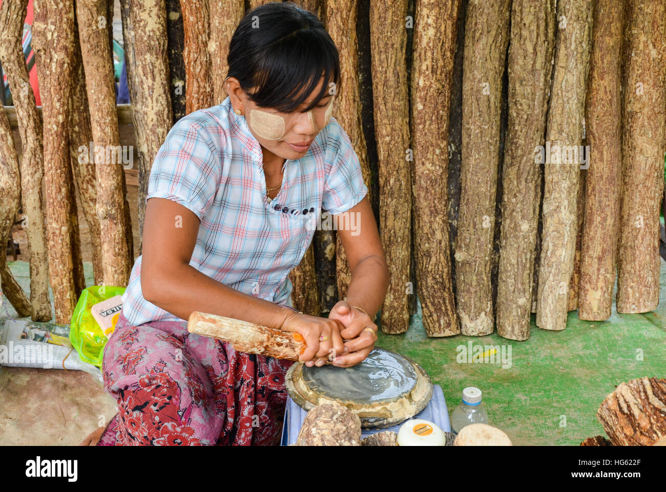 Unidentified burmese woman preparing tanaka, the traditional natural ...
