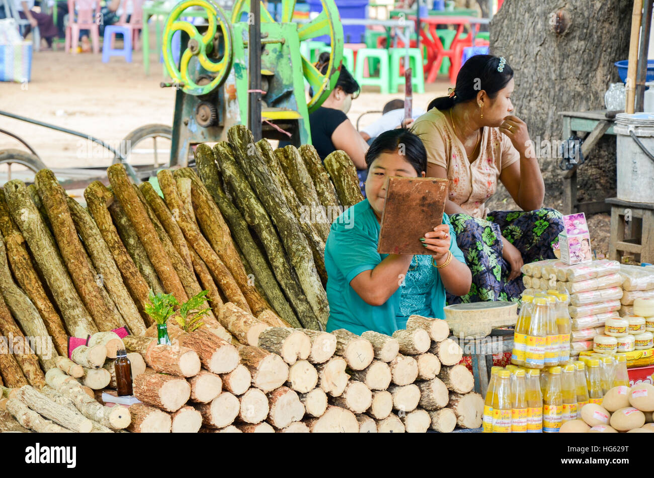 Unidentified burmese woman preparing tanaka, the traditional natural ...