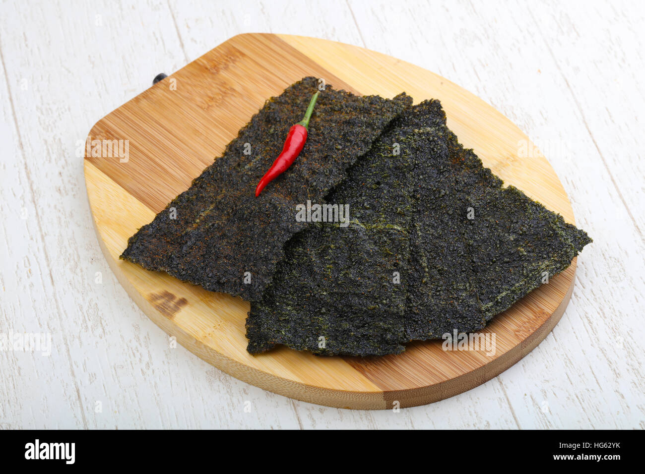 Spicy Nori seaweed sheets with pepper on wood Stock Photo - Alamy