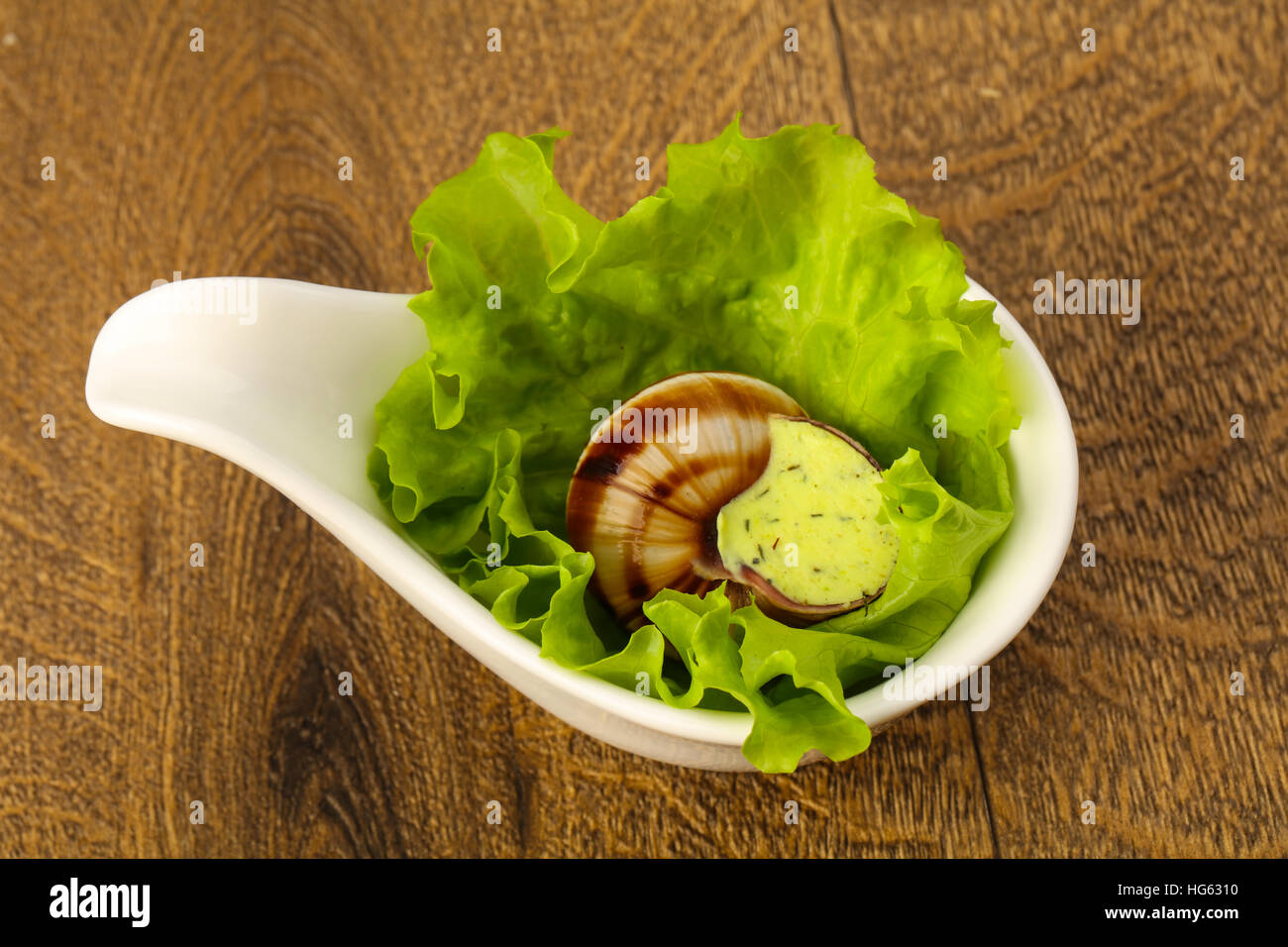 Escargot with cheese cream on salad leaves Stock Photo - Alamy