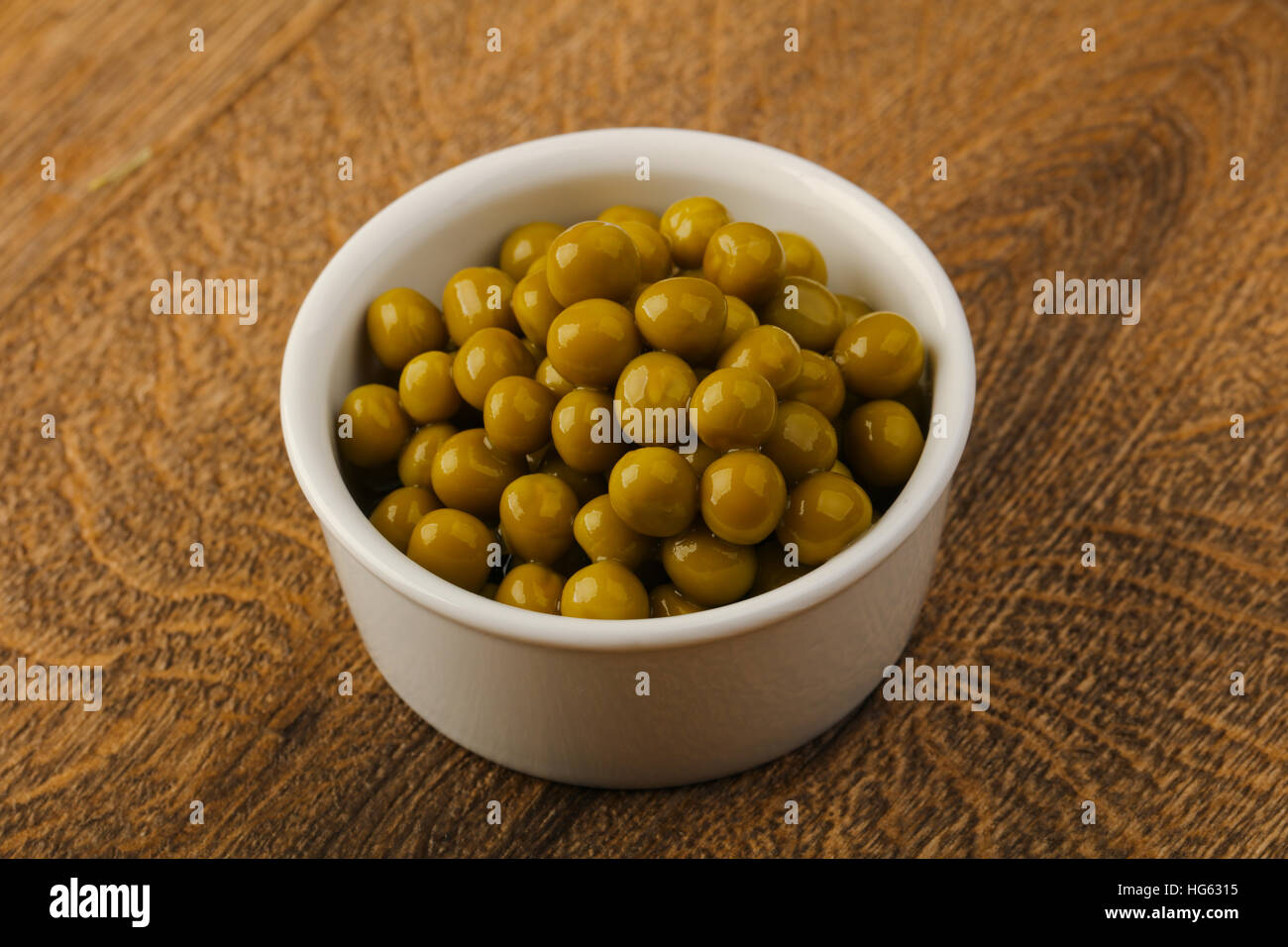 Pickled green pea on the wood background Stock Photo - Alamy