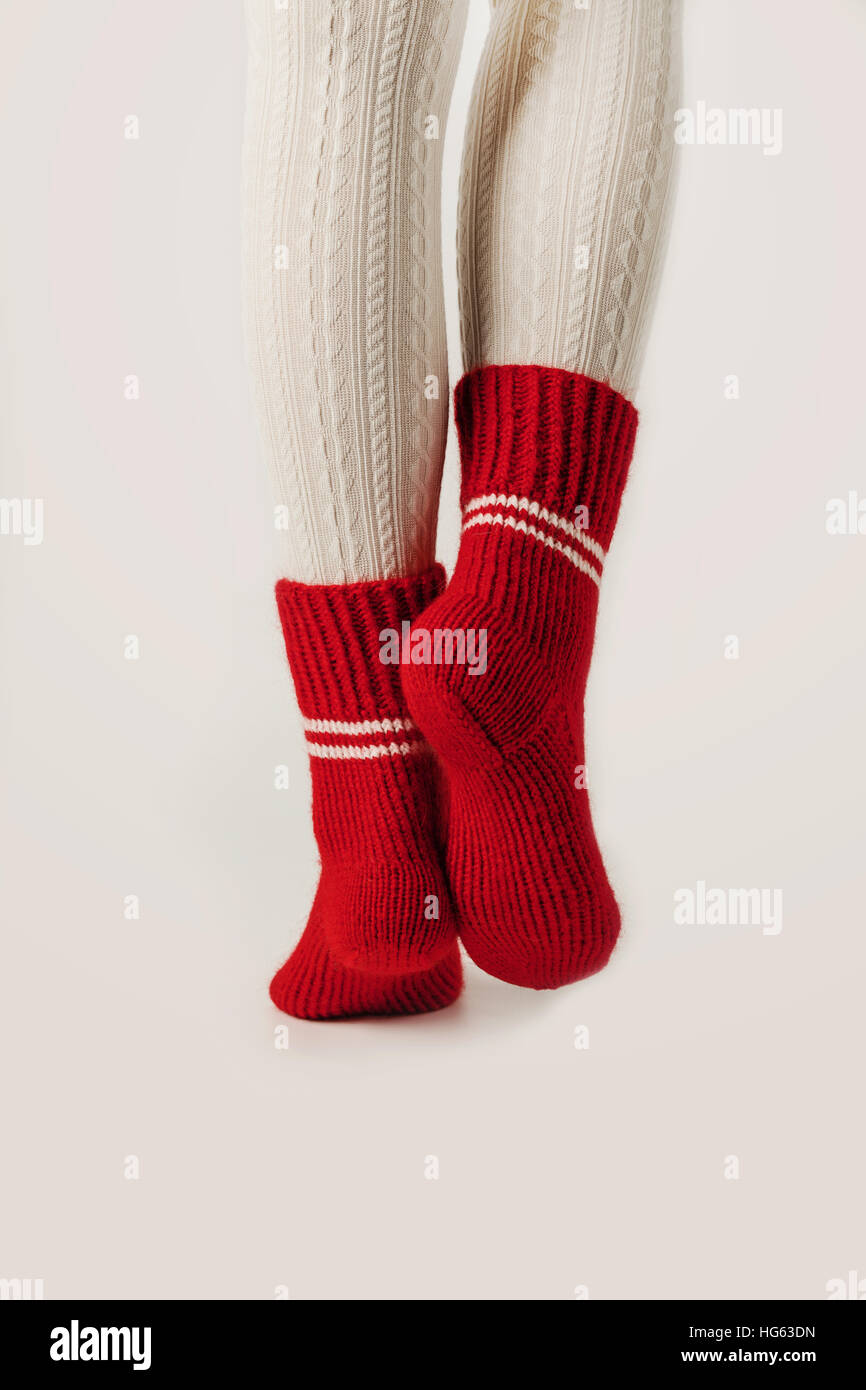 Female legs in white stockings and red knit socks Stock Photo - Alamy