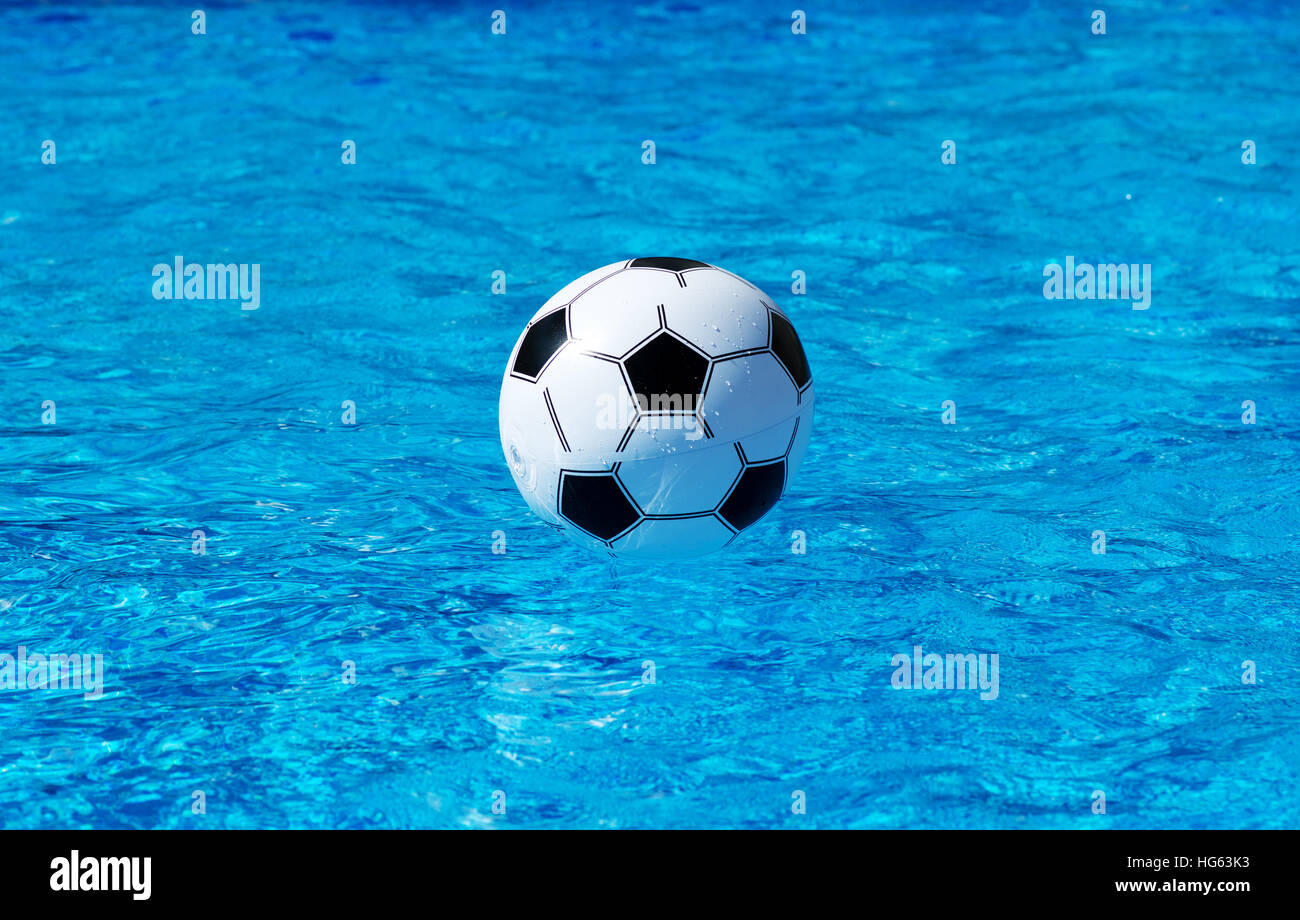 Beach ball floating in blue swimming pool. Space for text Stock Photo ...