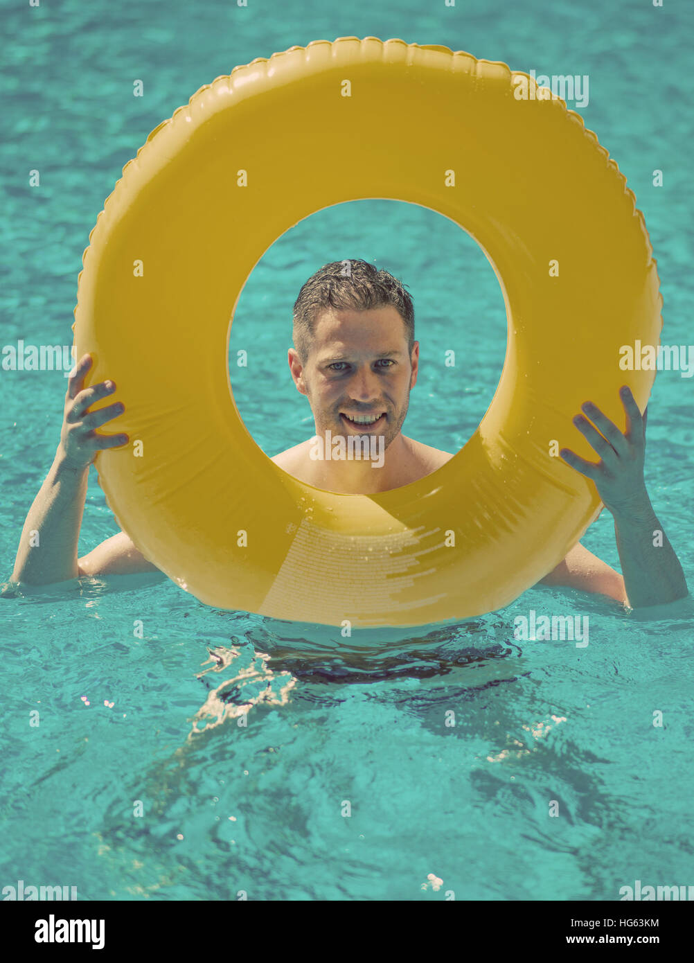 Man with inflatable rubber ring in swimming pool Stock Photo - Alamy