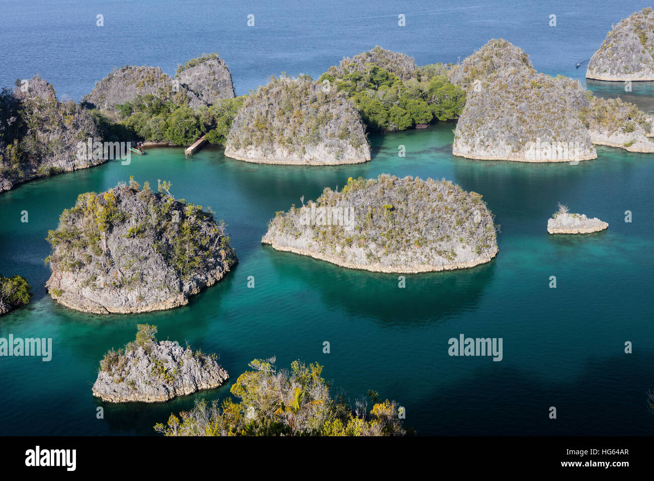 Limestone islands surround a beautiful lagoon in Raja Ampat, Indonesia ...