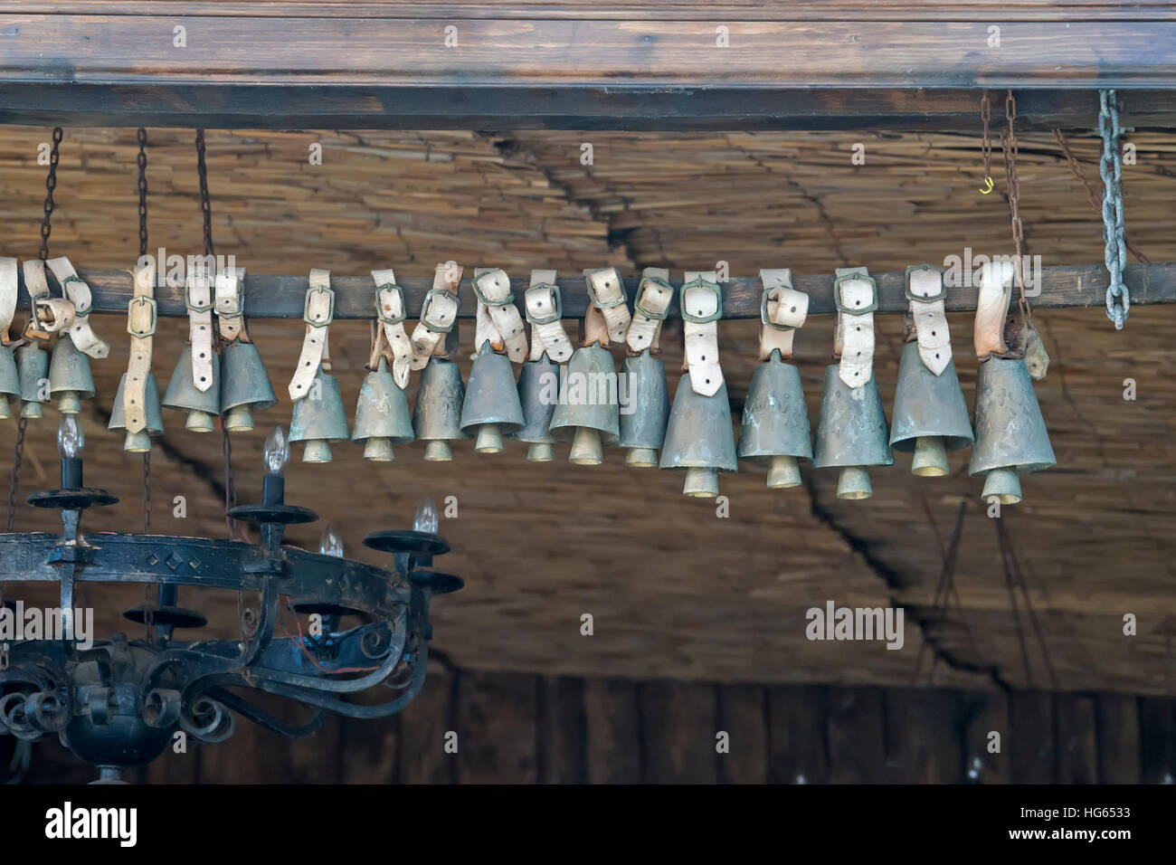 Animal bell hanging on a pole as a decoration Stock Photo - Alamy