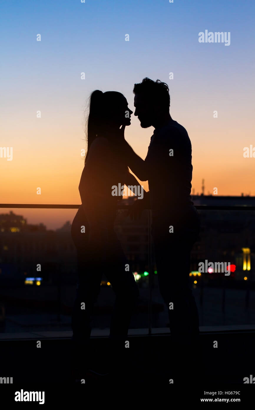 Couple and sunset sky background Stock Photo - Alamy