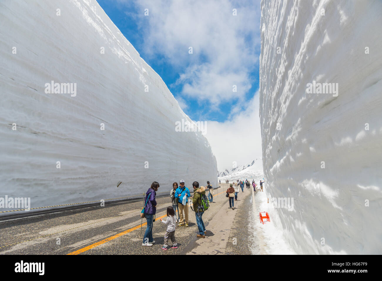 Tateyama, Japan - May 2, 2014: Unidentified tourists walk along snow ...