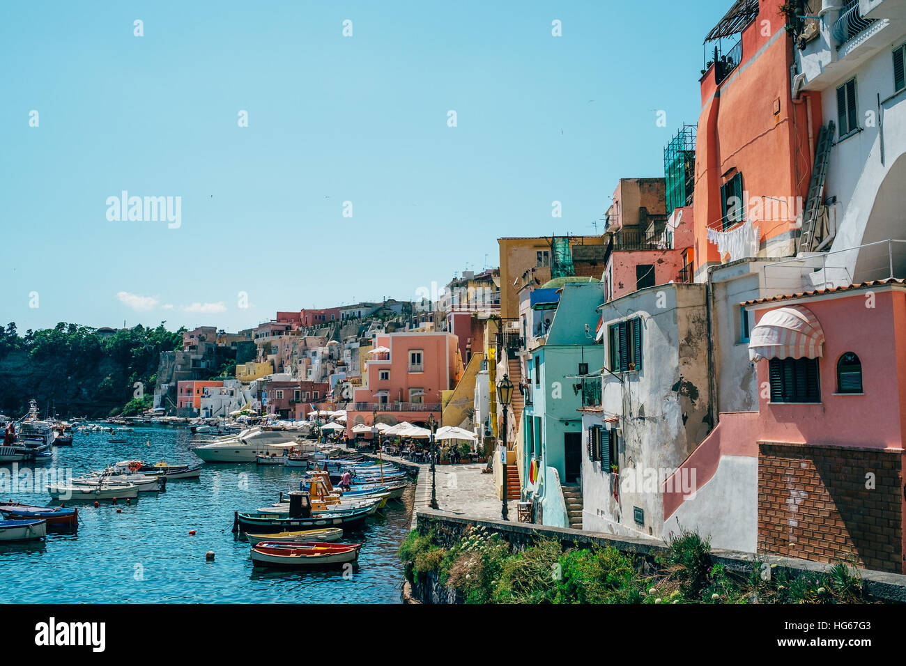 Brightly coloured houses line the harbour of the island of Procida ...