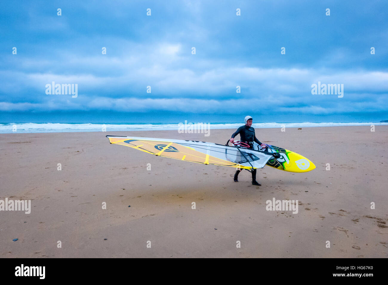 Surfer on the beach in Cornwall Stock Photo - Alamy