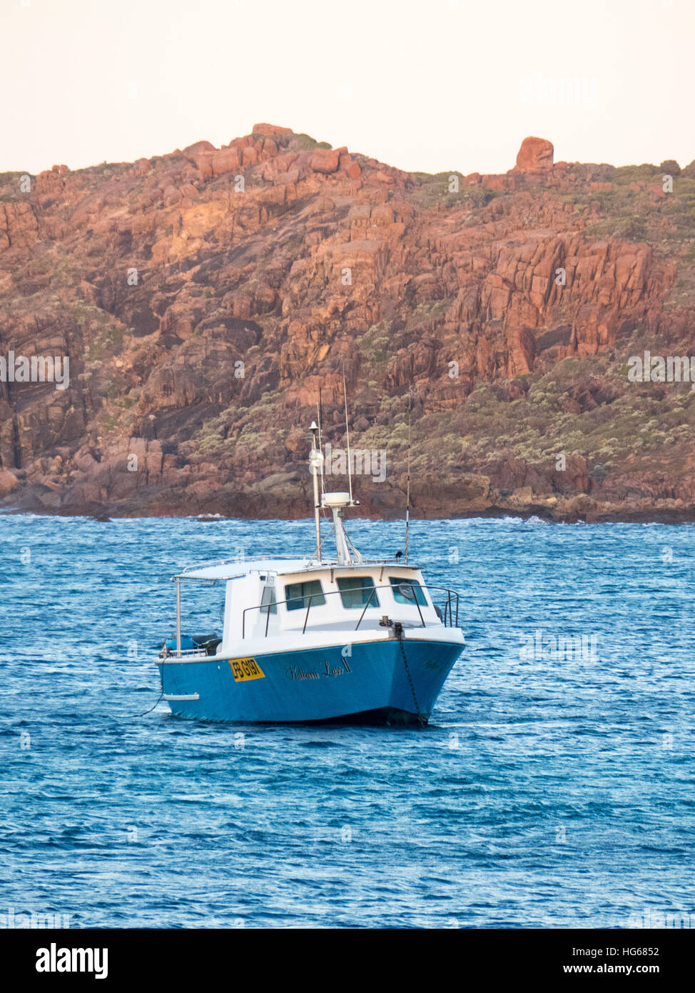 A fishing boat moored in a bay near Canal Rocks, Leeuwin-Naturaliste ...