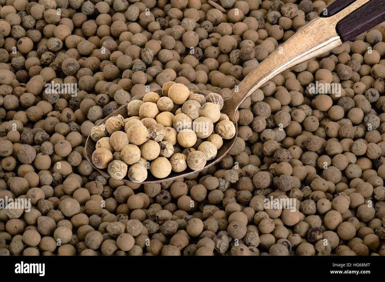 White Pepper on Old Brass Spoon Stock Photo - Alamy