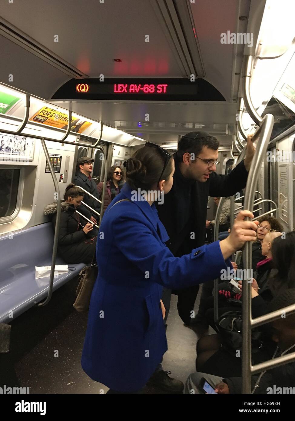 New York, NY, USA. 1st Jan, 2017. Passengers on the Q subway train on ...