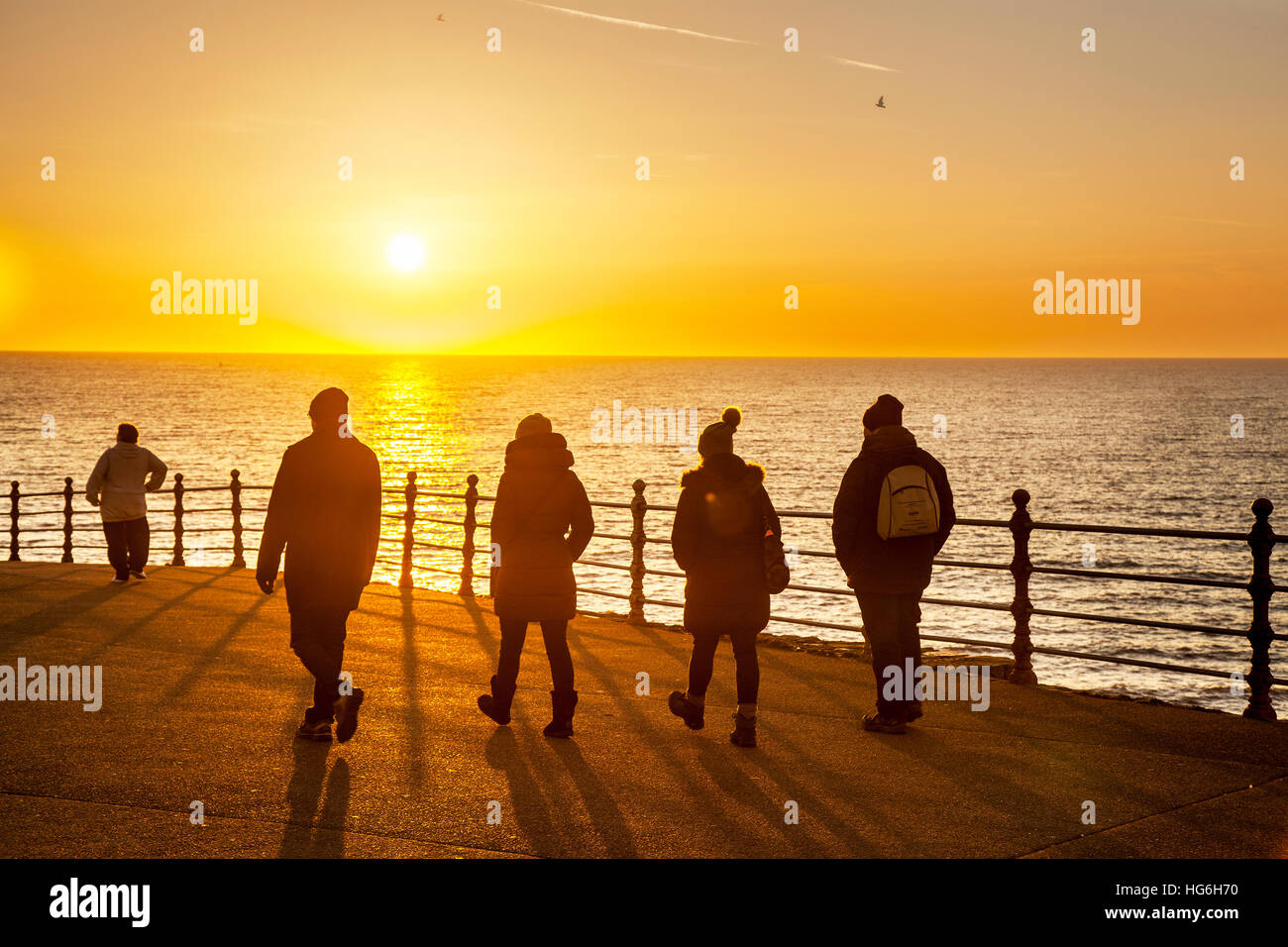 Coastal promenade walkway, sunset, people, shadow, walking, silhouette ...