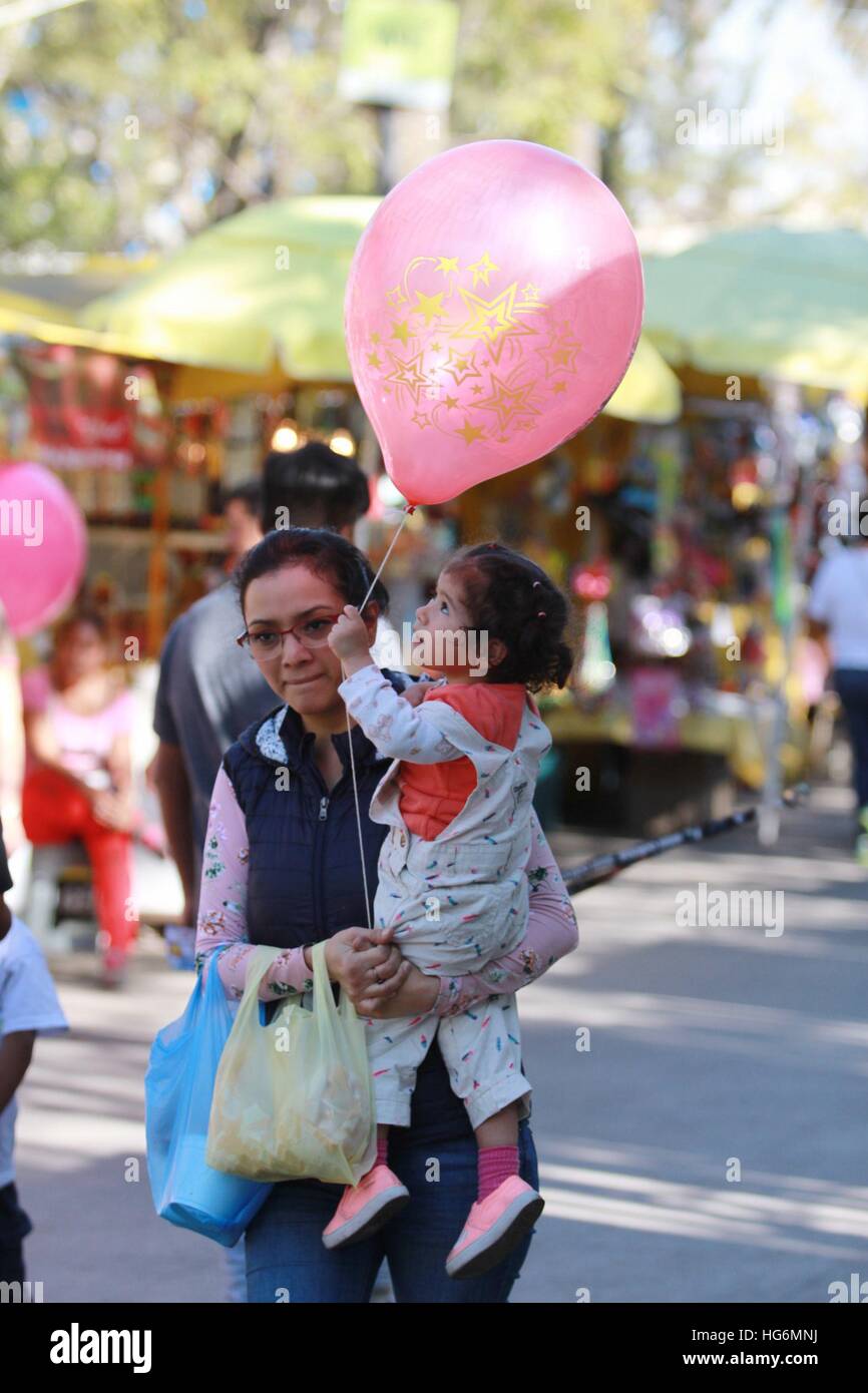Mexico City, Mexico. 5th Jan, 2017. A woman carries her daughter who ...