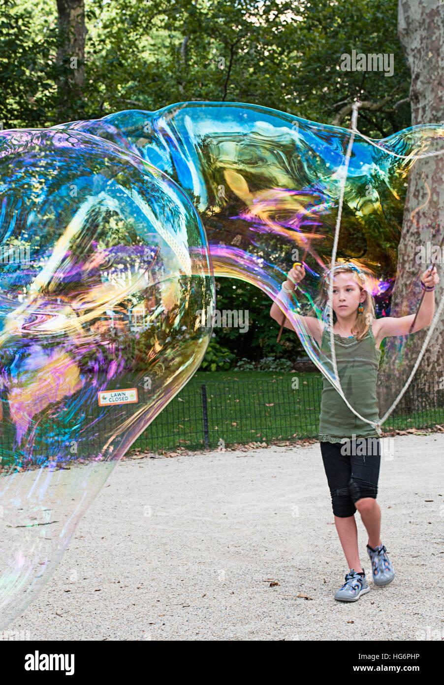 A girl making a giant bubble at Madison Park, New York City Stock Photo ...