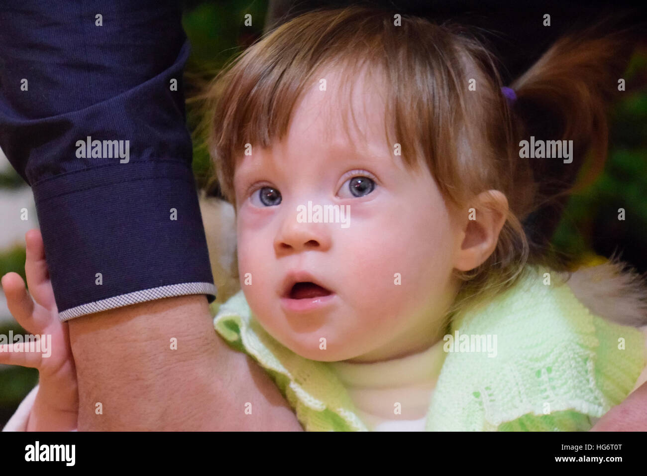 Surprised girl. Child Mimicry. Year-old girl with dad in the background ...