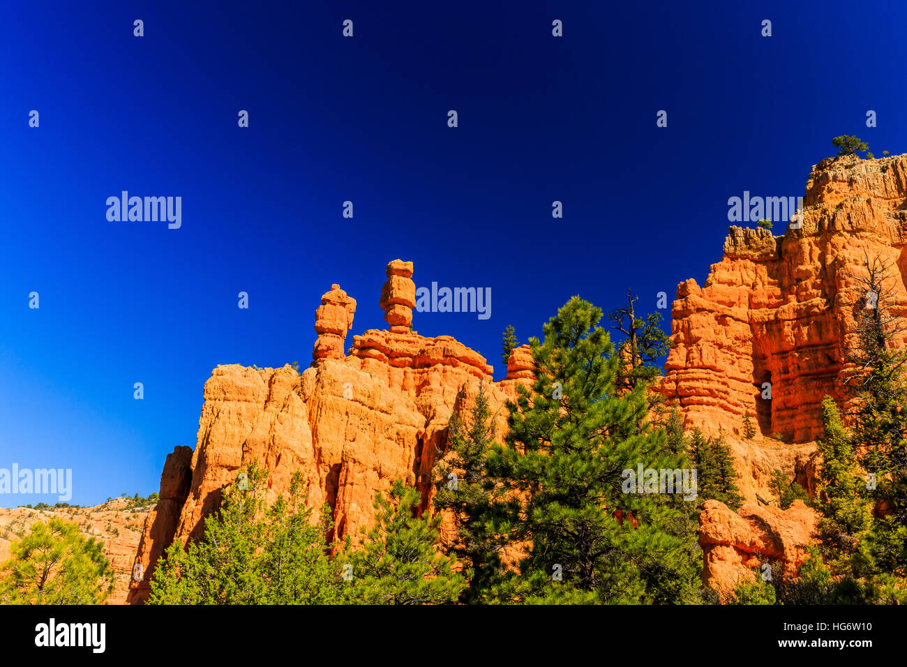 Unique vermilion-colored rock formation and stands of Ponderosa pines ...