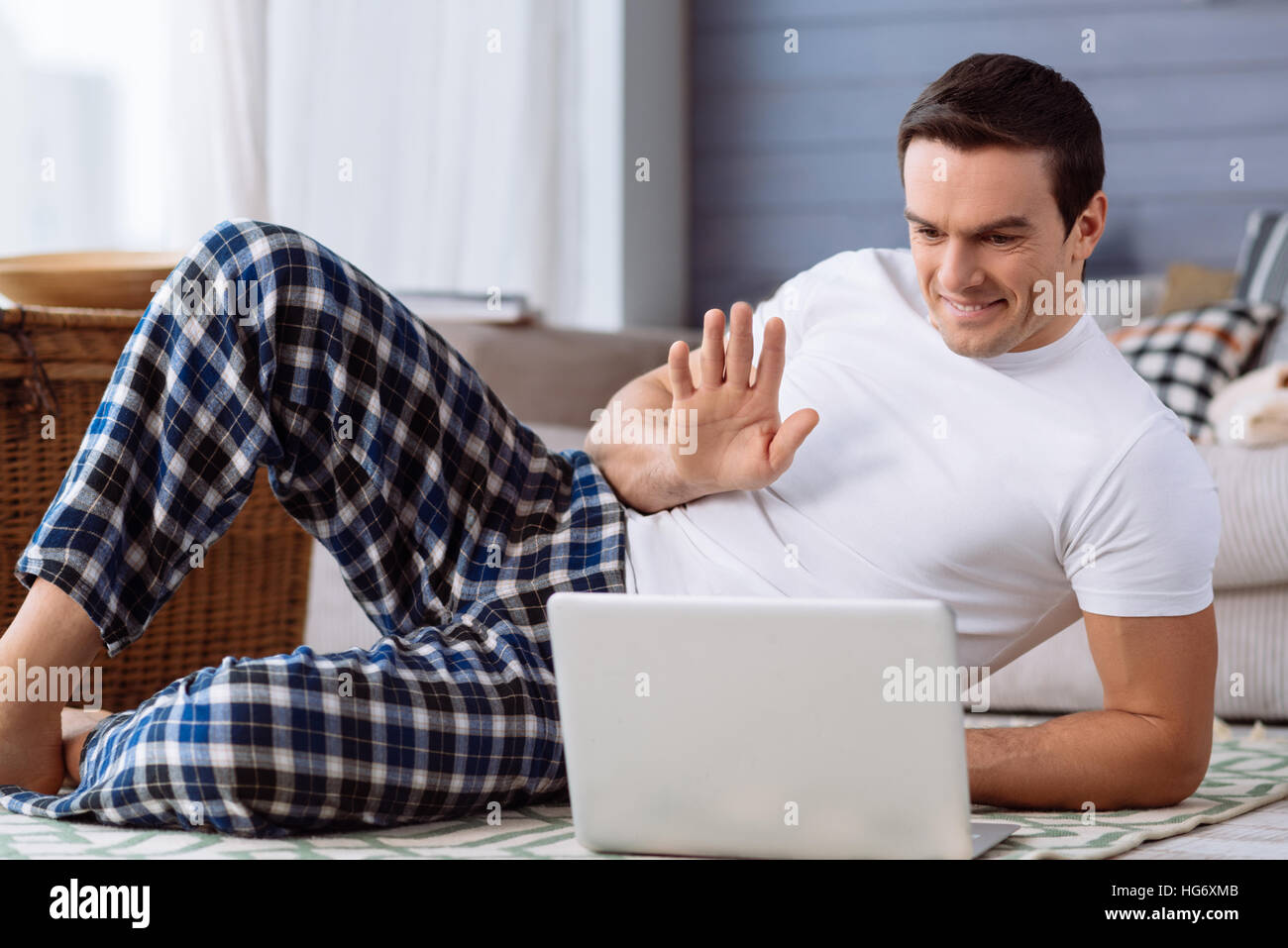 Positive delighted man making a video call Stock Photo - Alamy