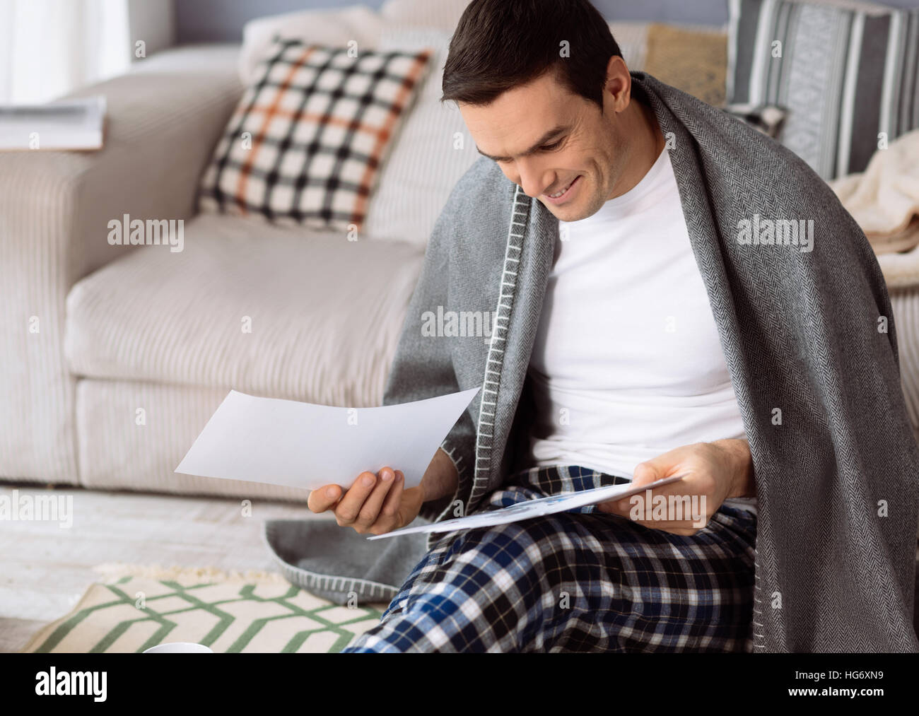Cheerful self employed man holding some documents Stock Photo - Alamy