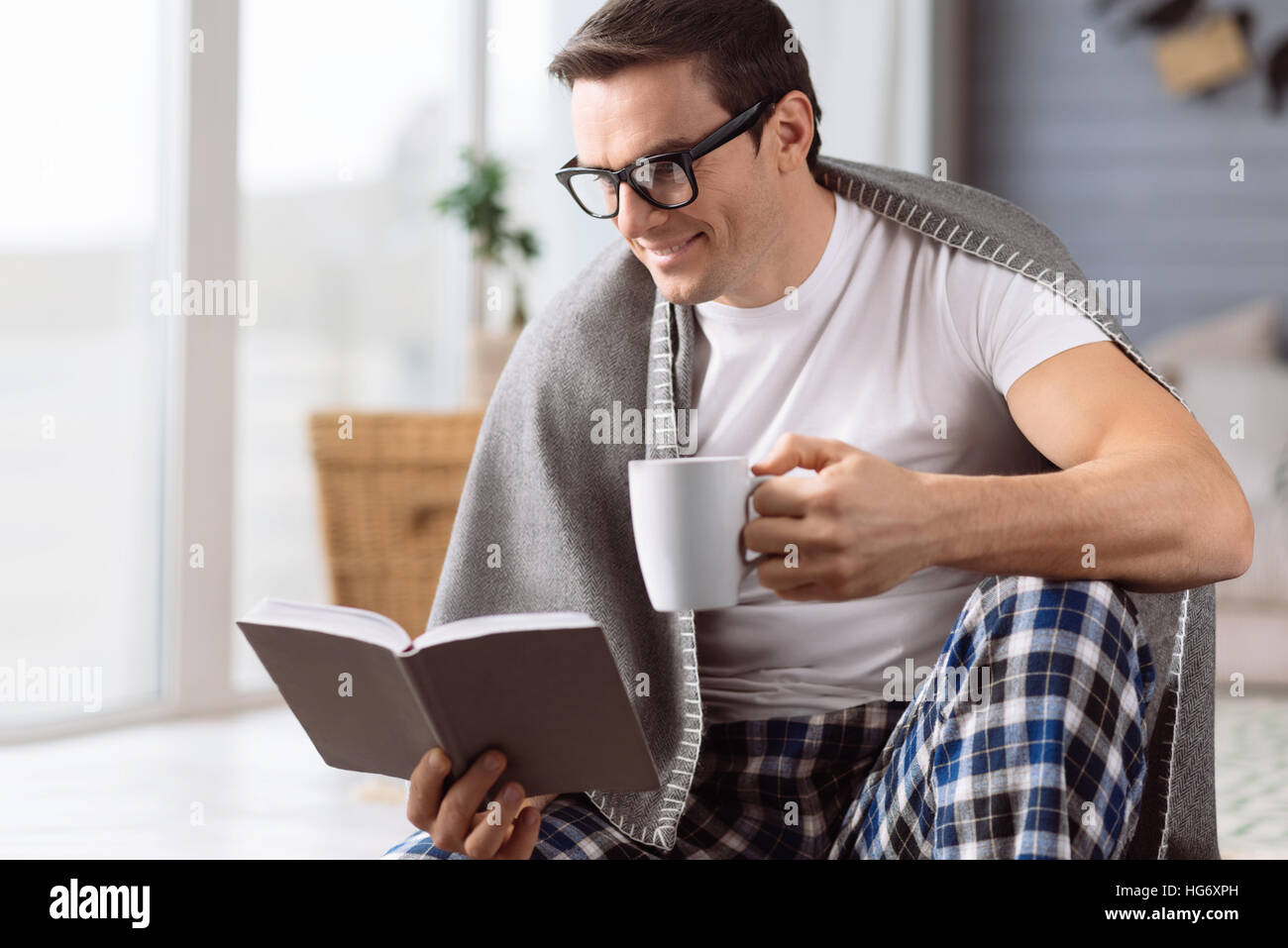 Intelligent handsome man reading a book Stock Photo - Alamy