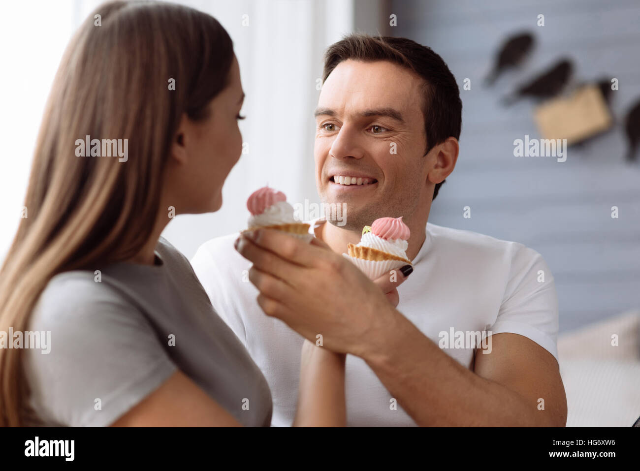 Cheerful positive man feeding his girlfriend Stock Photo - Alamy
