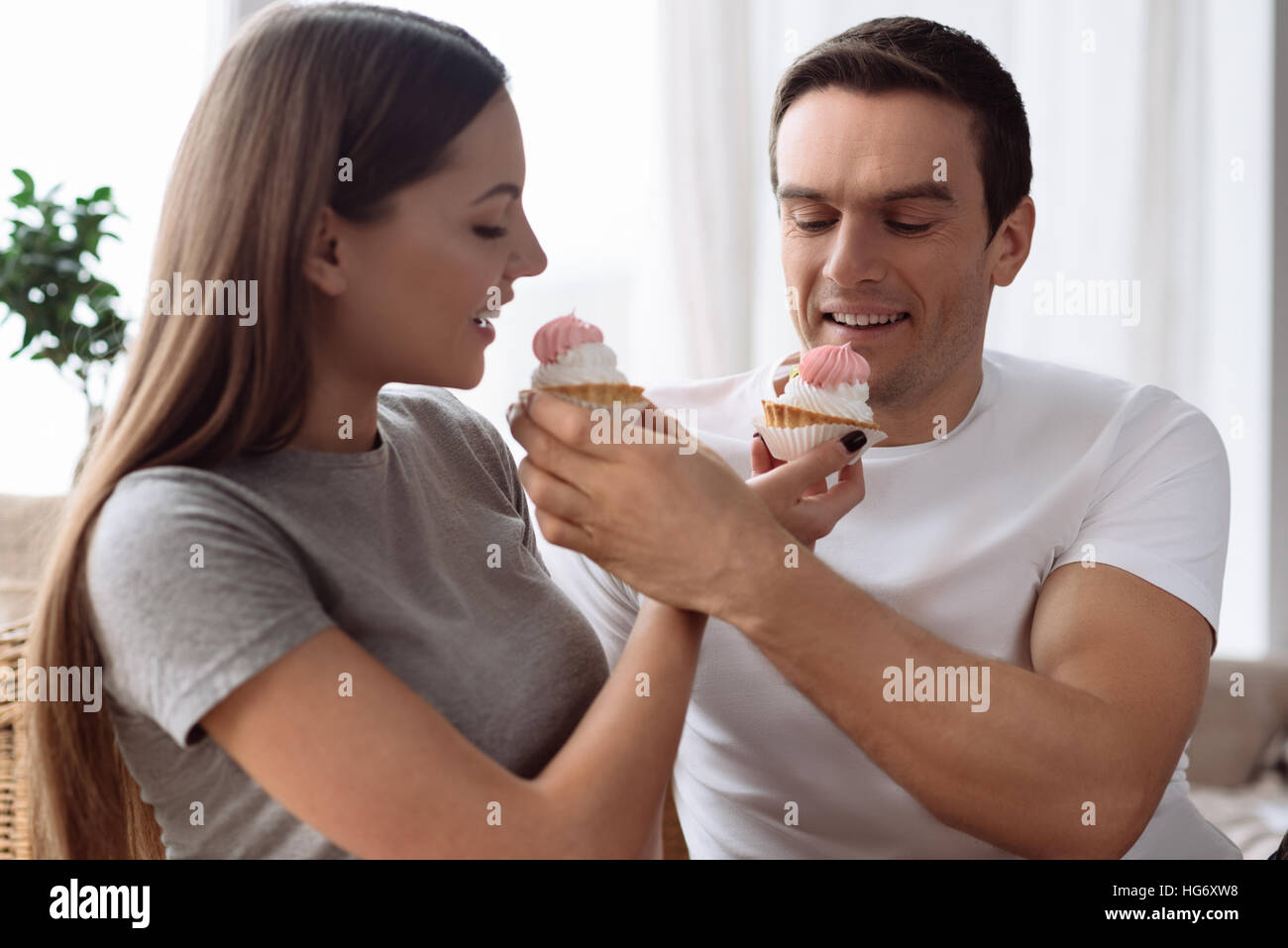 Happy good looking couple feeding each other Stock Photo - Alamy