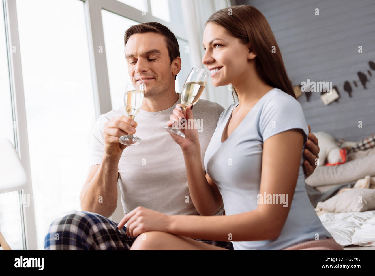 Joyful young couple drinking champagne Stock Photo - Alamy