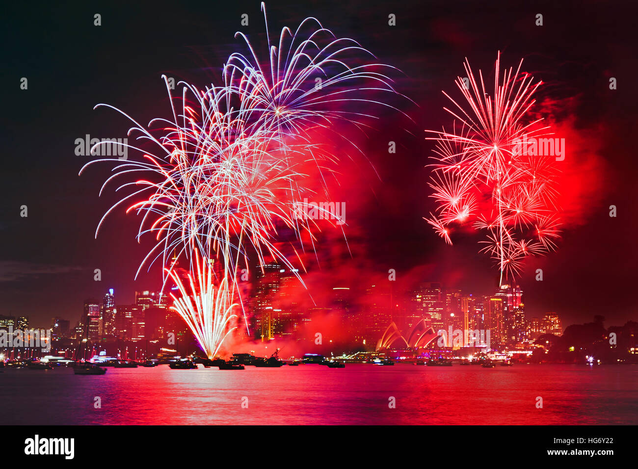 Bright red balls of new year eve fireworks in Sydney across illuminated ...