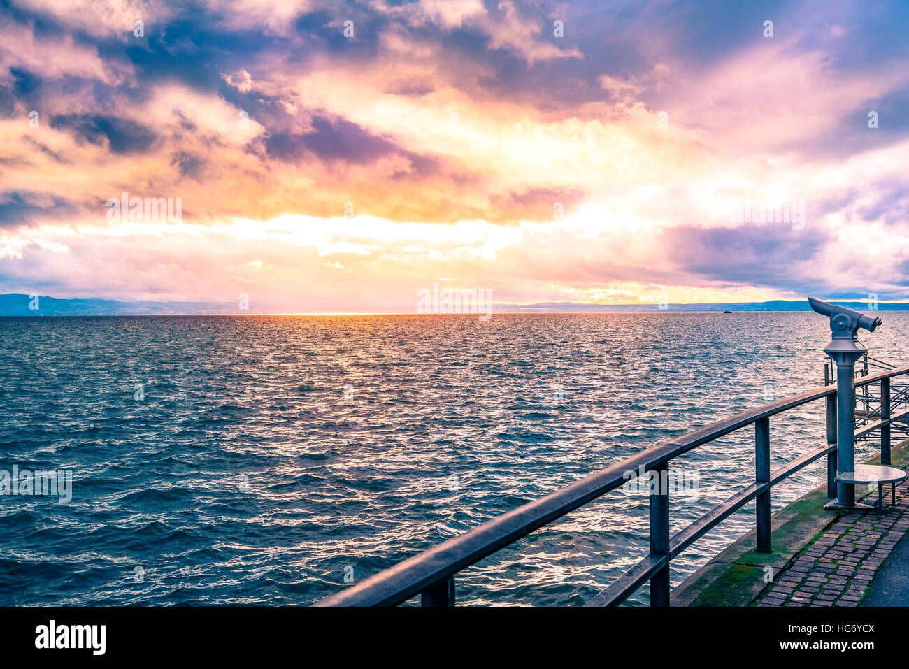 Landscape with a colorful sunset over the Bodensee lake and its shore ...