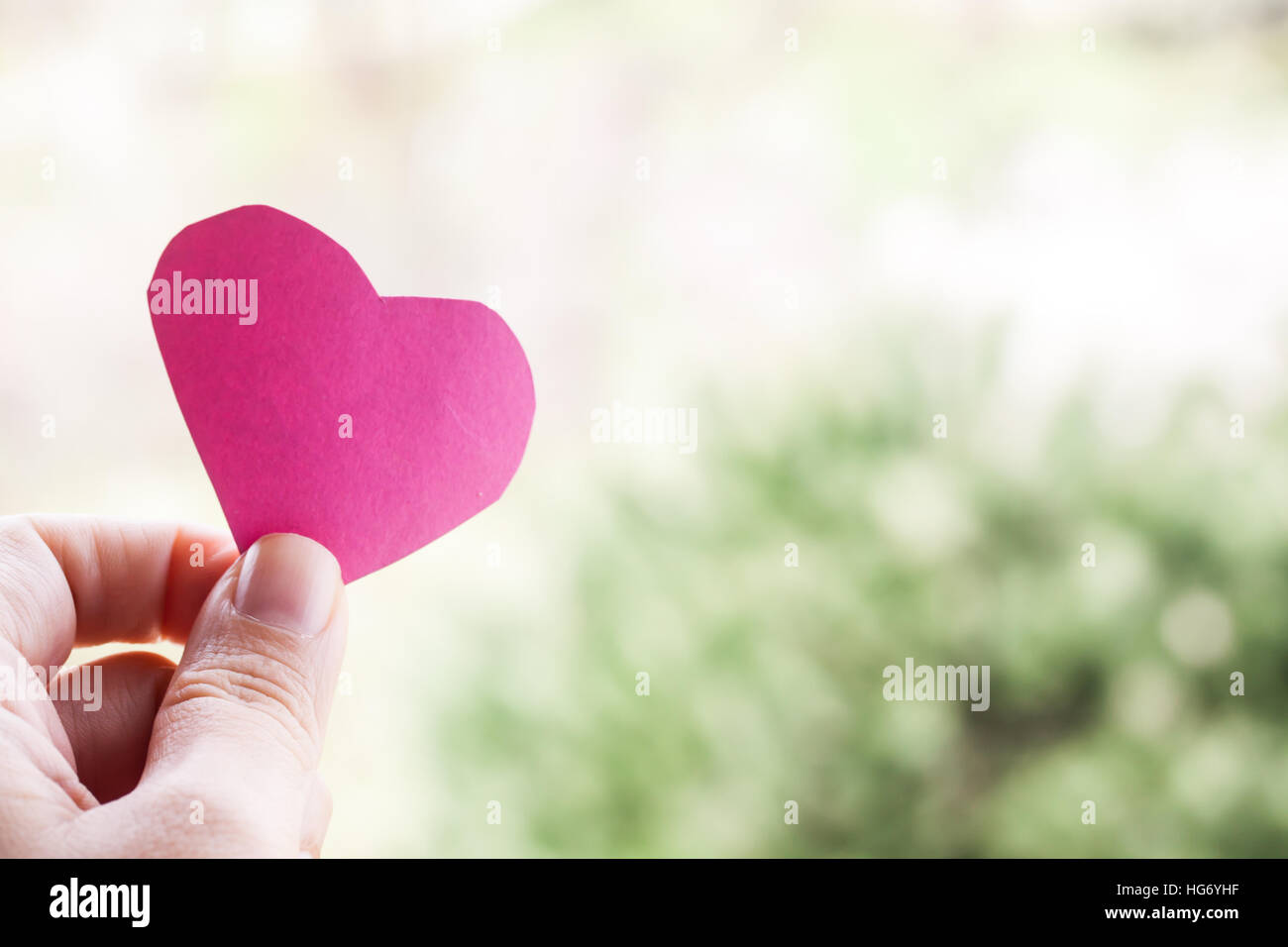 hand holding pink paper heart Stock Photo - Alamy