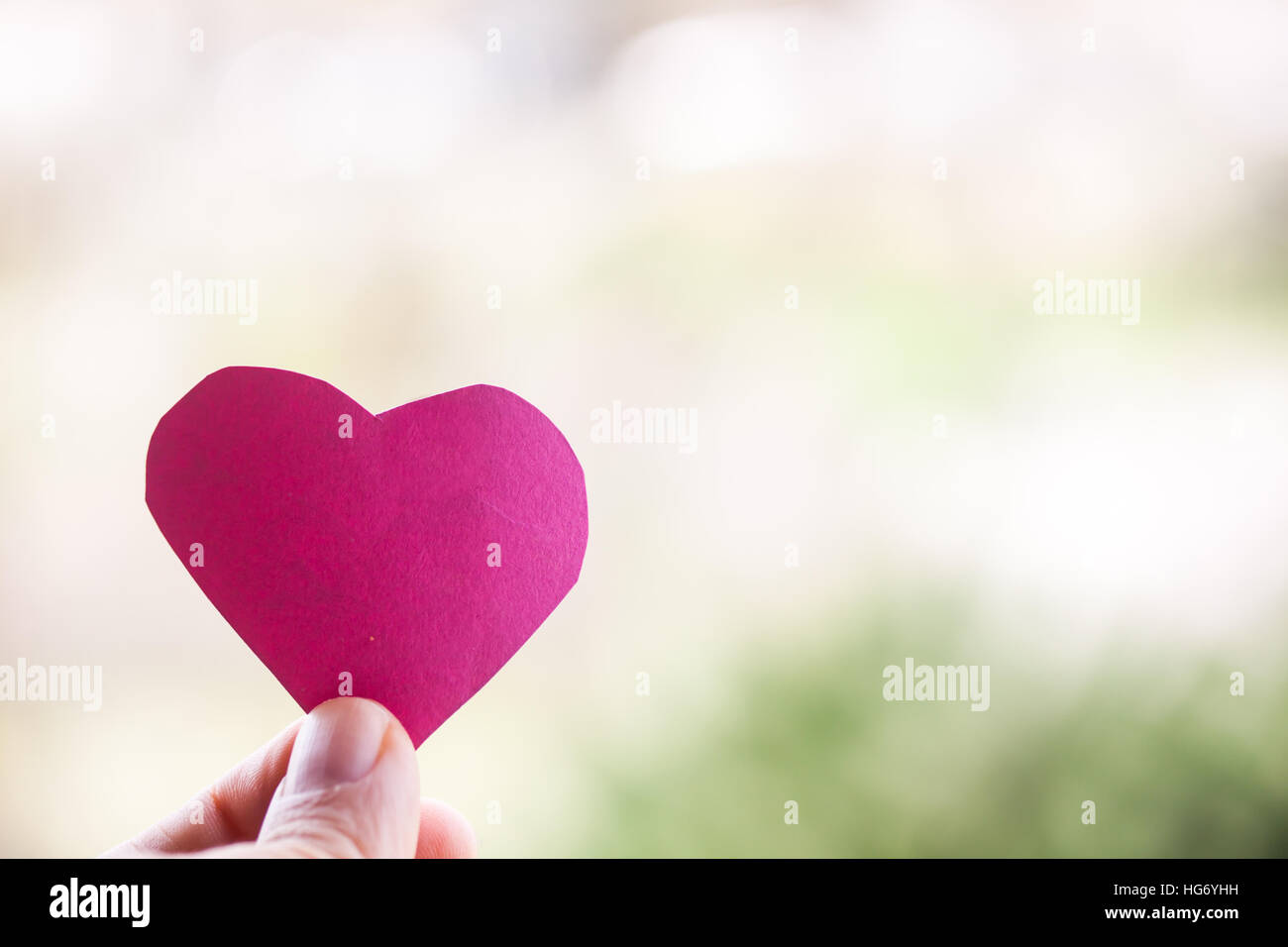 hand holding pink paper heart Stock Photo - Alamy