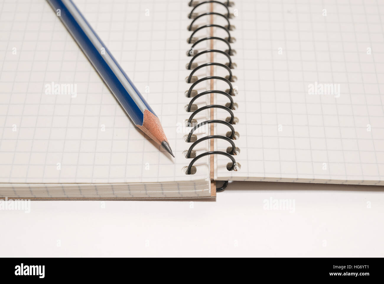Pencil on the pages of an open notebook Stock Photo - Alamy