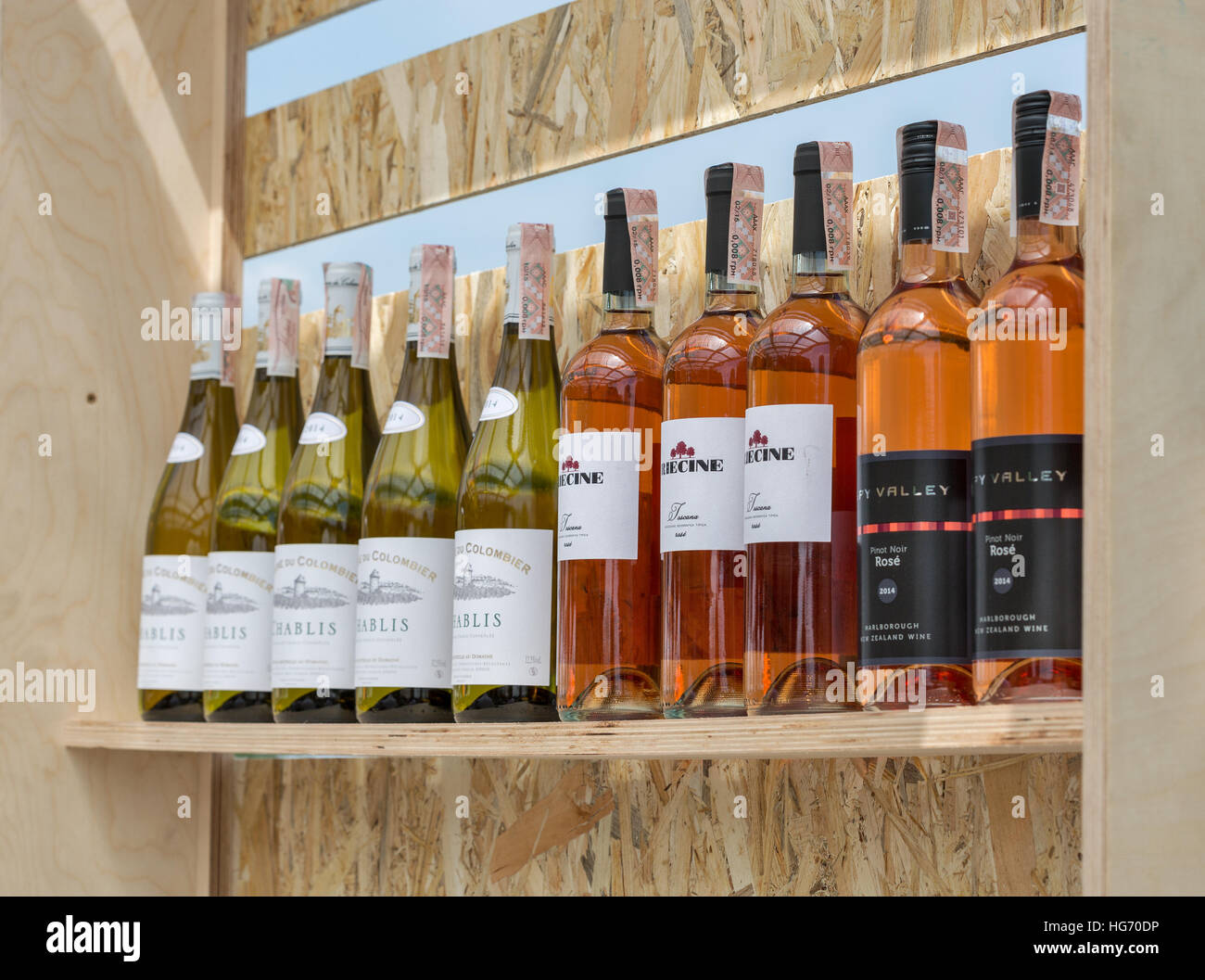 Different wines in a row presented on the wooden shelf of outdoor food ...