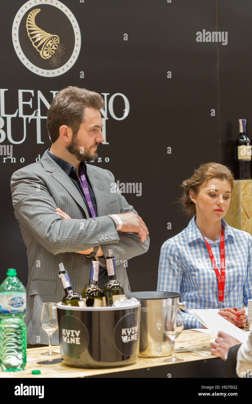 Unrecognized presenters work on winery booth at Kyiv Wine Festival ...
