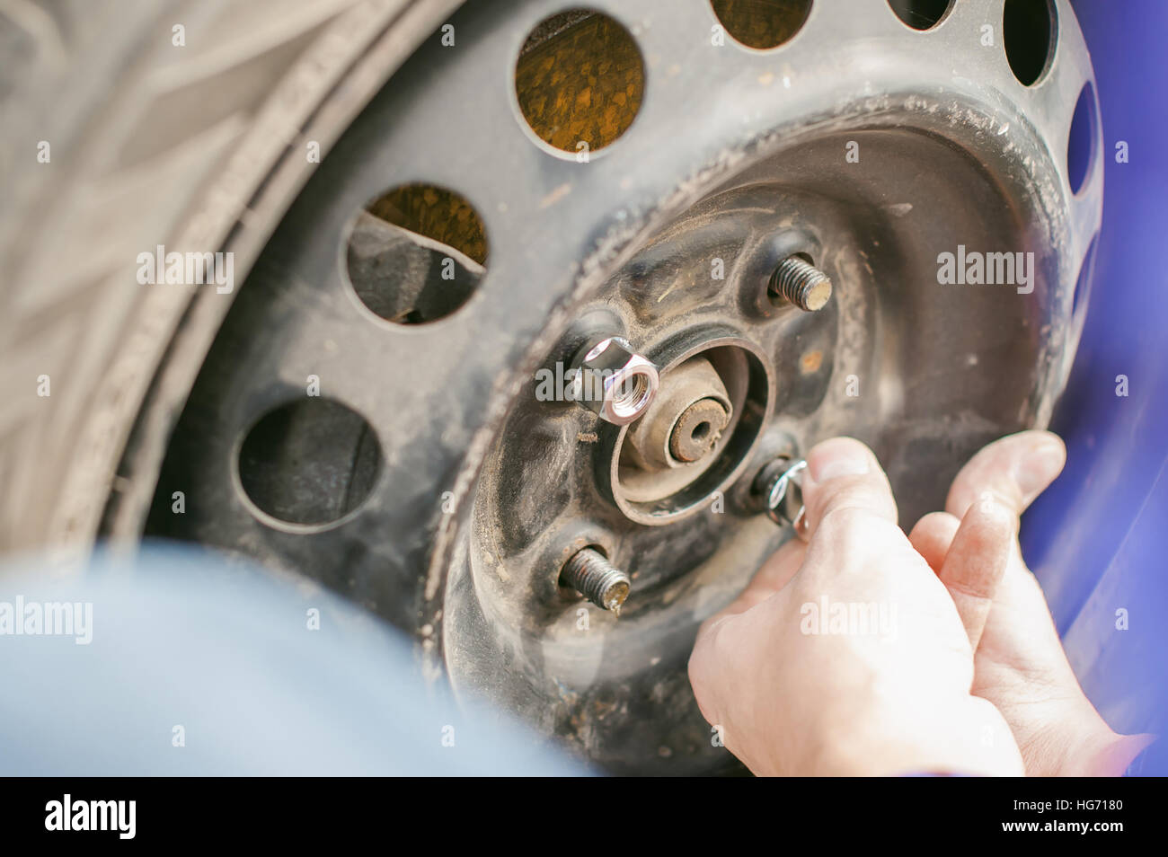 man changing a wheel on the road. on way there was breakage of wheel ...