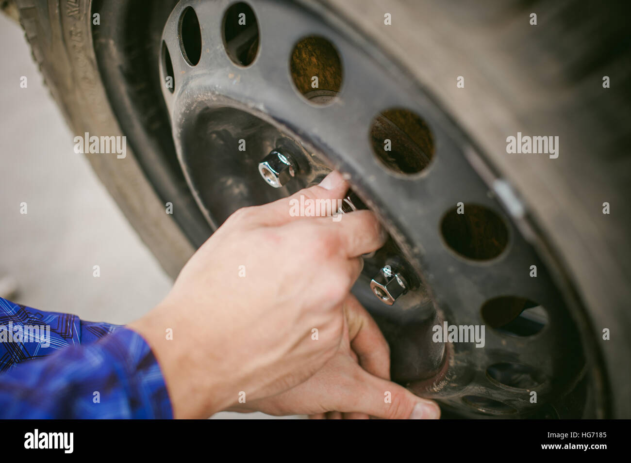 man changing a wheel on the road. on way there was breakage of wheel ...