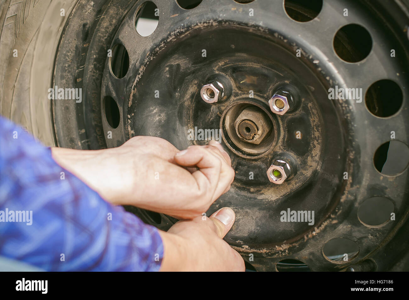 man changing a wheel on the road. on way there was breakage of wheel ...