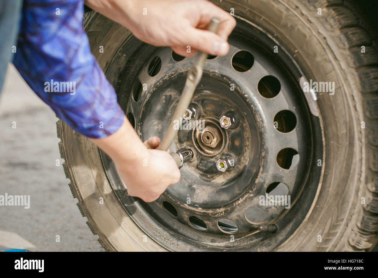 man changing a wheel on the road. on way there was breakage of wheel ...