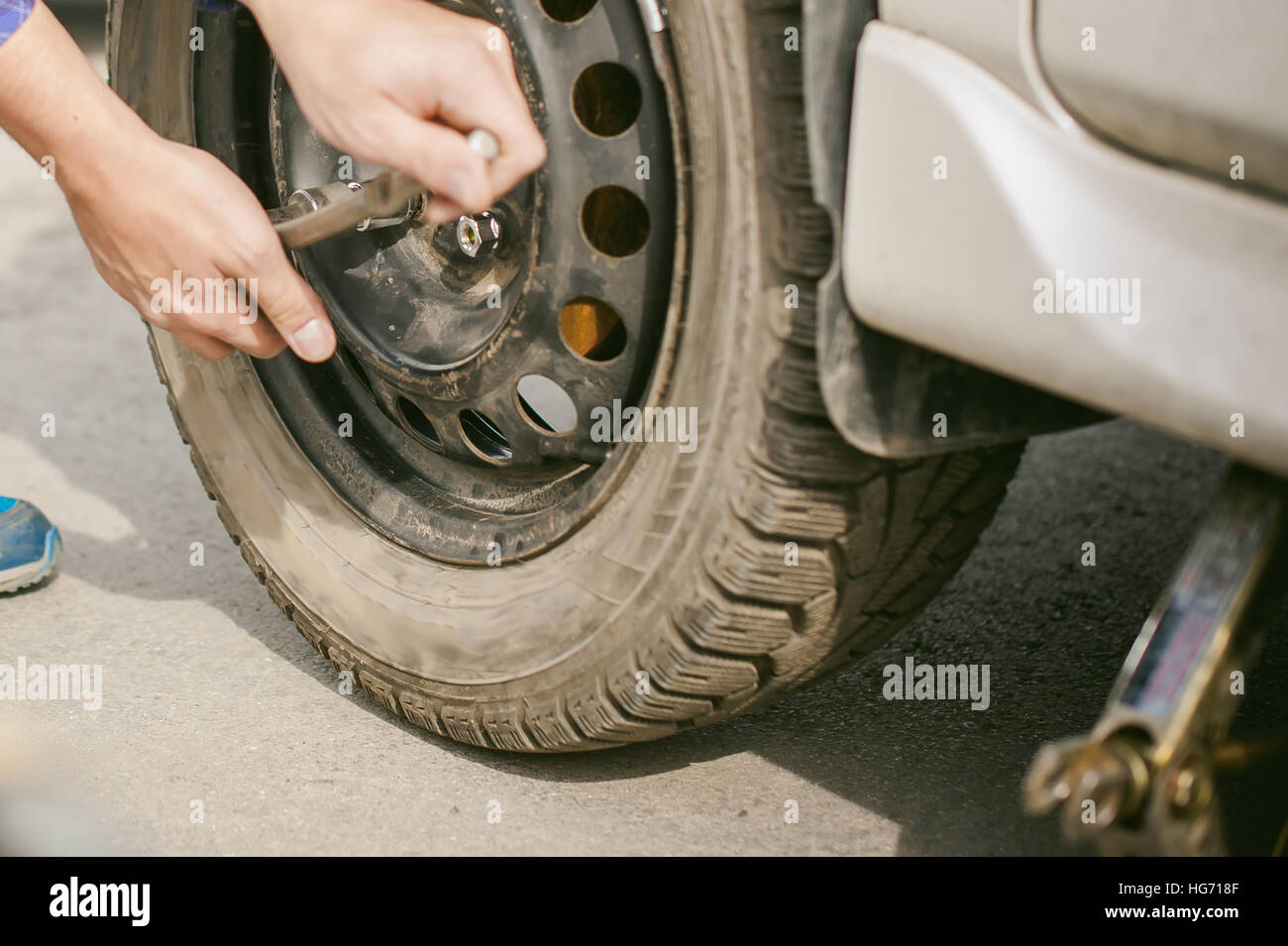 man changing a wheel on the road. on way there was breakage of wheel ...