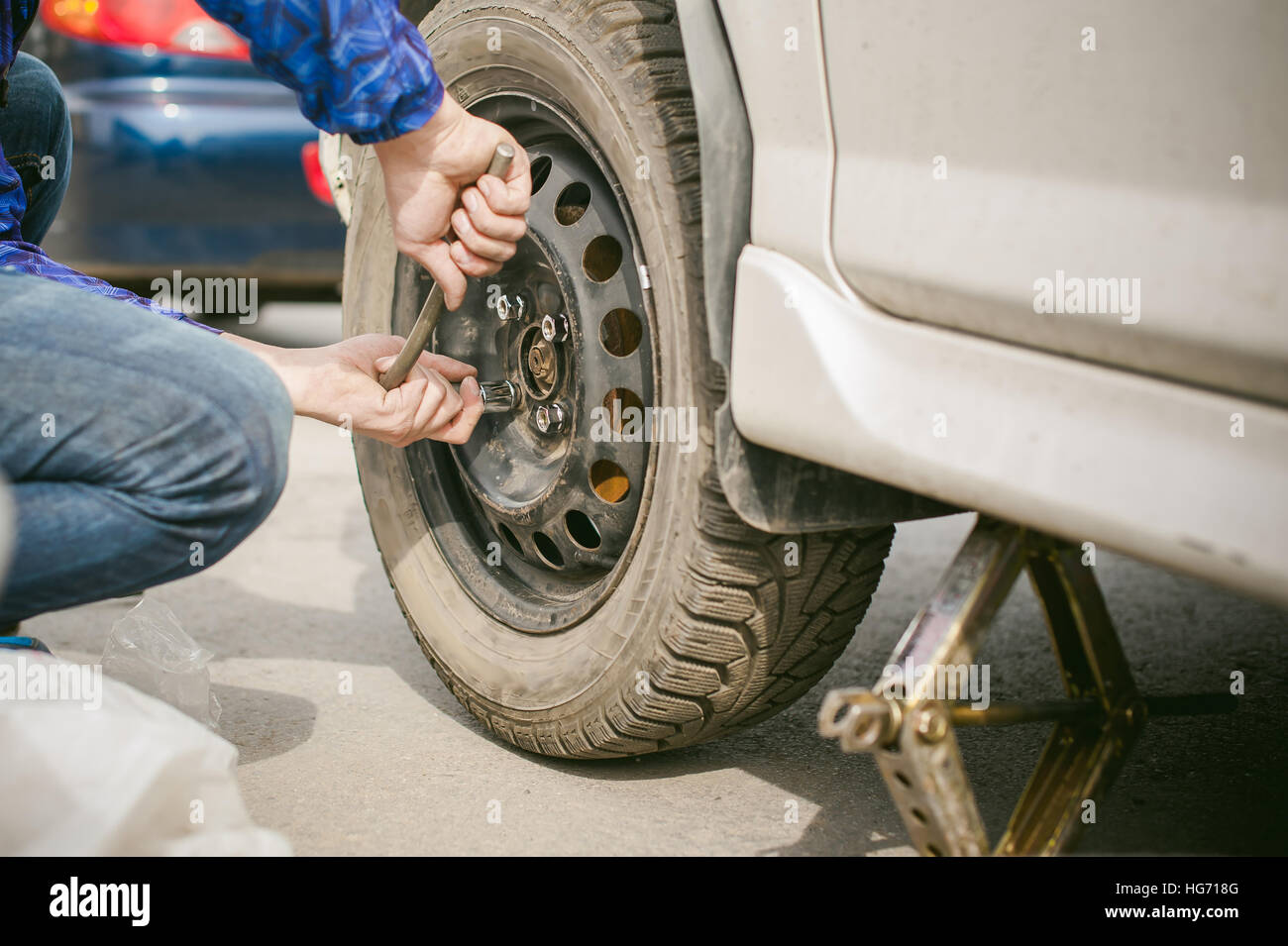 man changing a wheel on the road. on way there was breakage of wheel ...