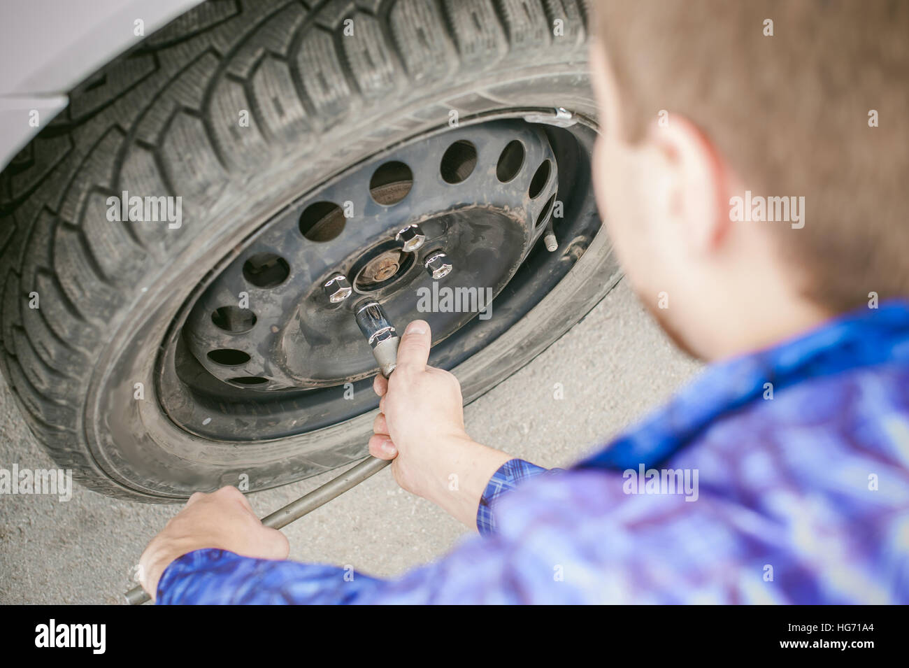 man changing a wheel on the road. on way there was breakage of wheel ...