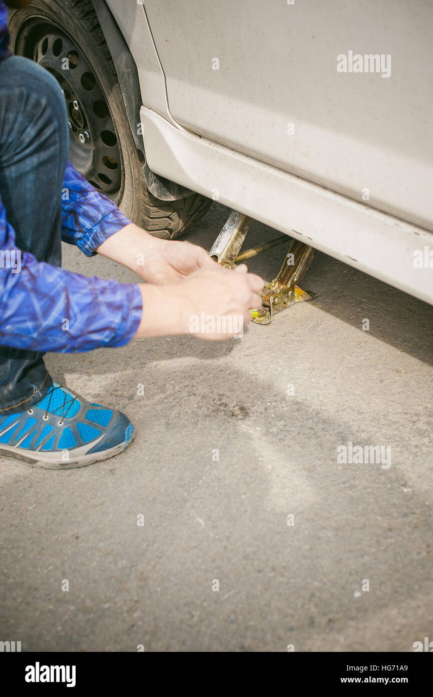 man changing a wheel on the road. on way there was breakage of wheel ...